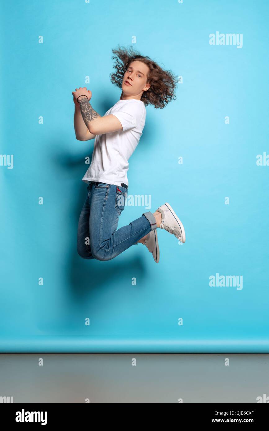 Full-length portrait of young man, student in casual style outfit ...
