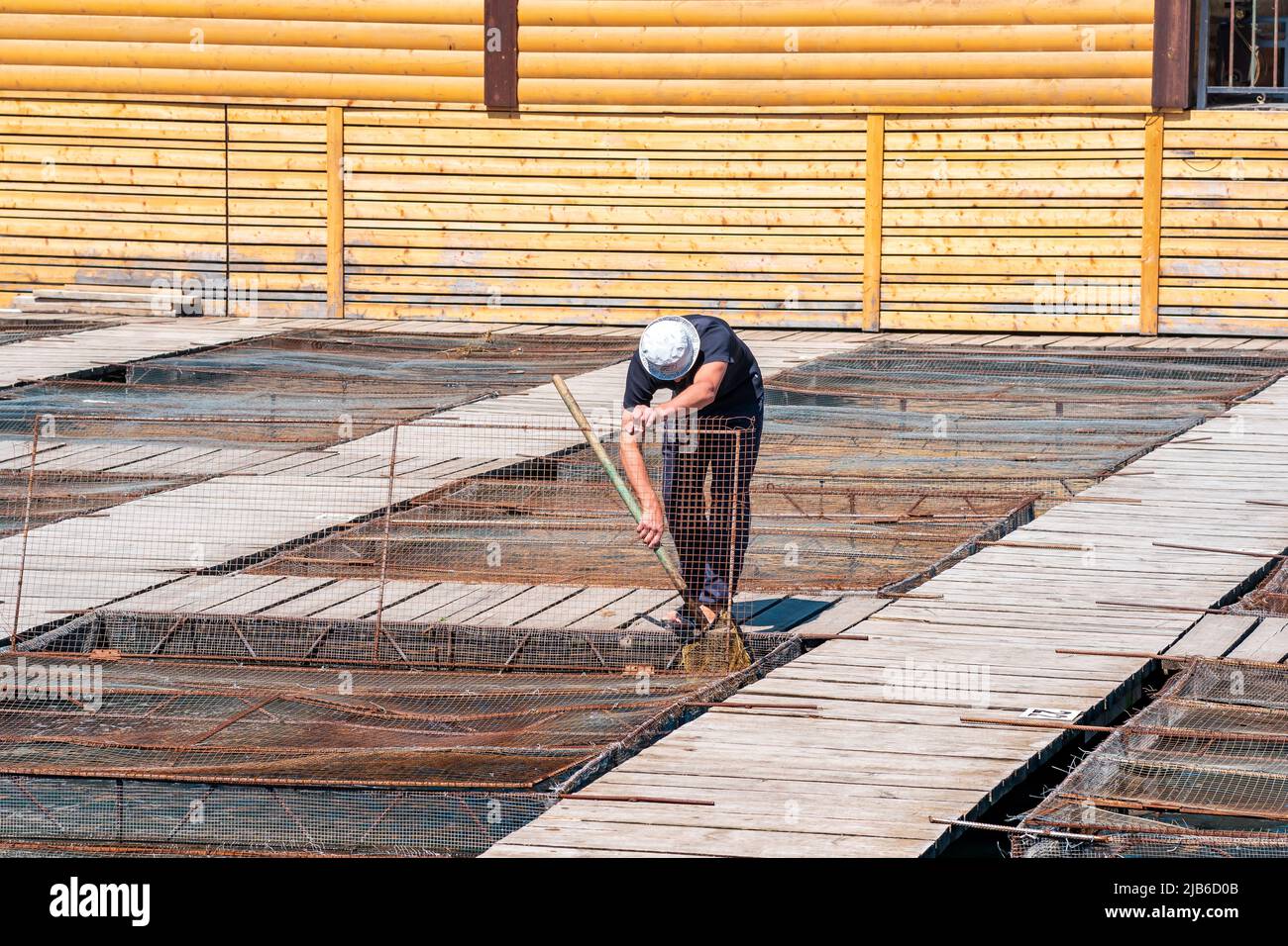 Dagestan, Russia - May 13, 2022: worker at a fish farm maintain ...