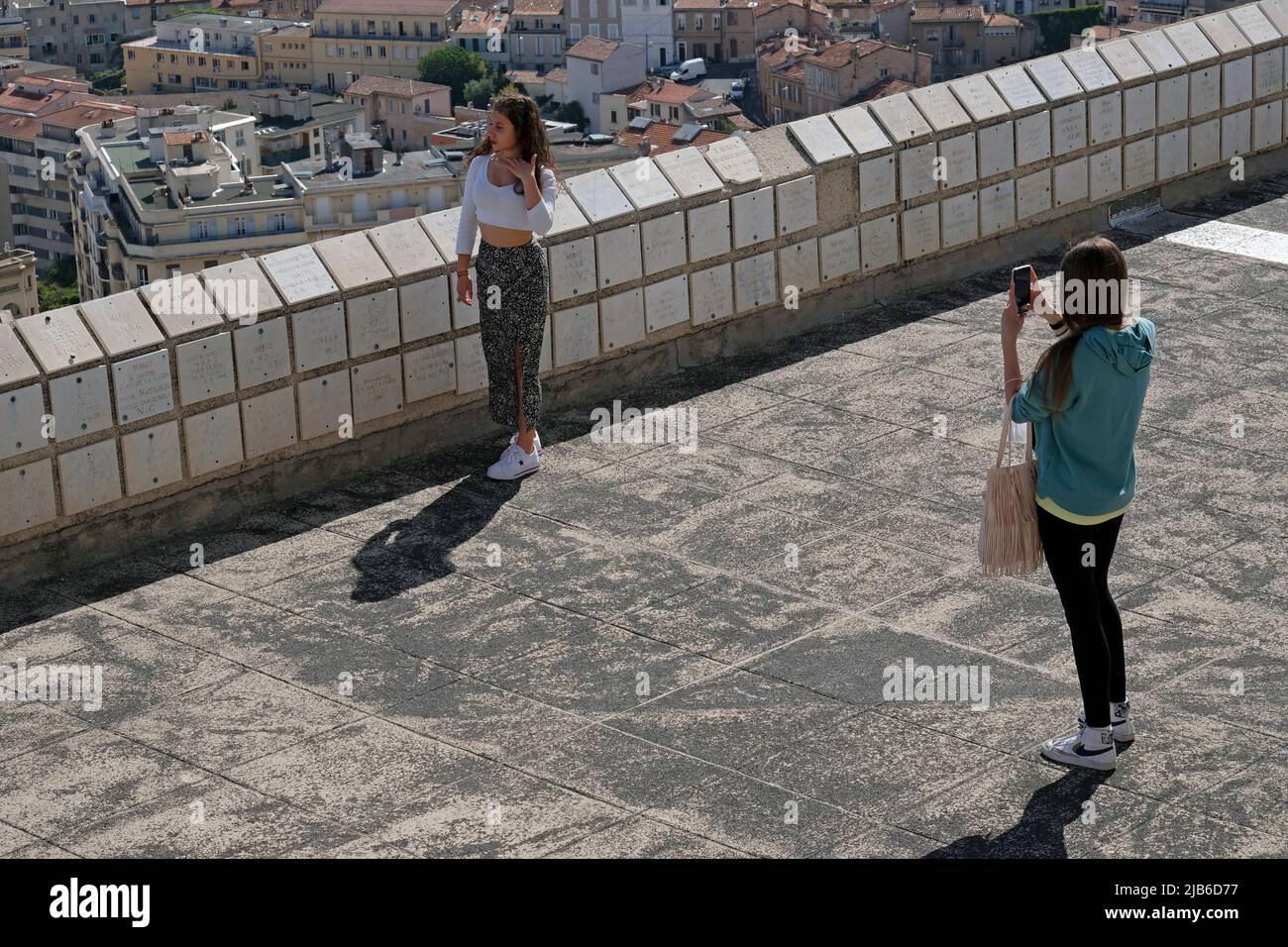17 May 2022 - Marseille, France: Two young women taking smartphone ...
