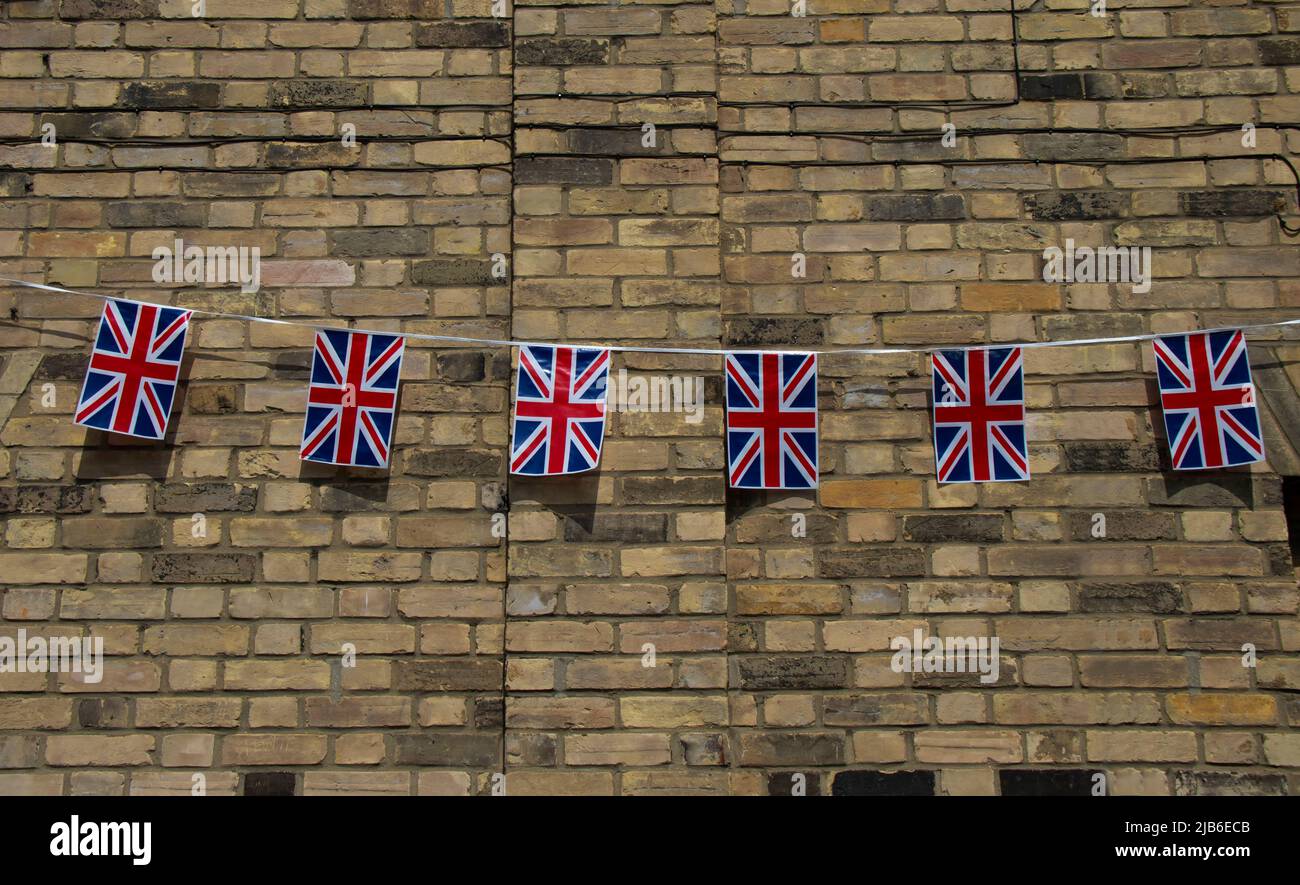 Union flag bunting on display in a village in Suffolk, UK Stock Photo ...