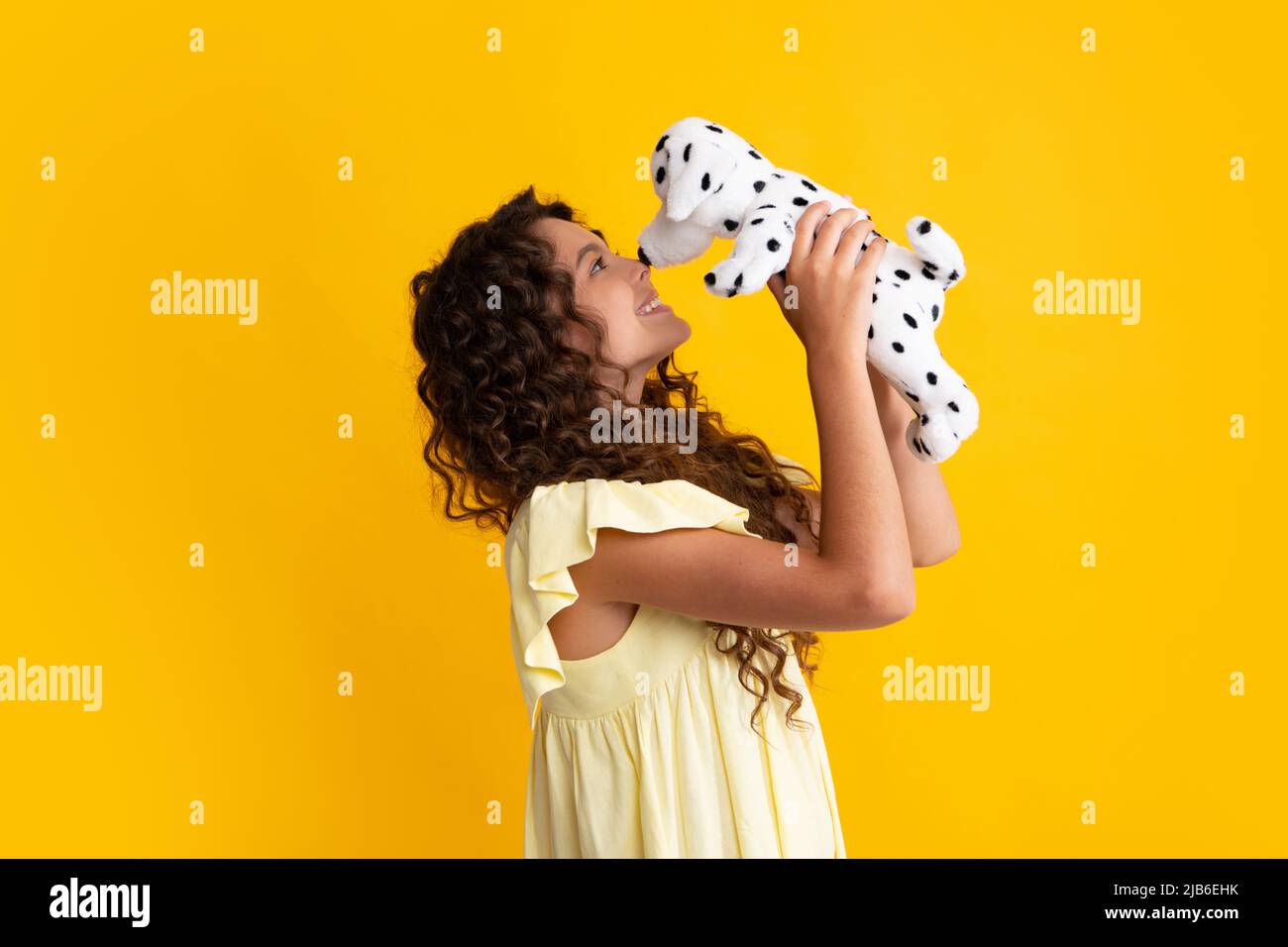 Childhood, toys and kids. Cute teen girl cuddling fluffy toy. Happy ...