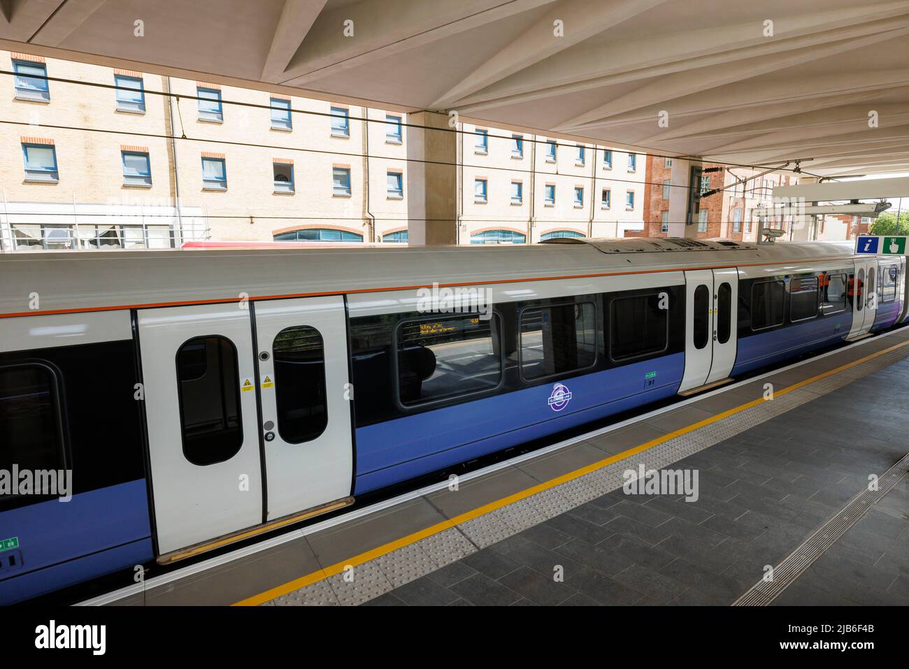 A new train runs on the Elizabeth Line at Custom House in east London ...