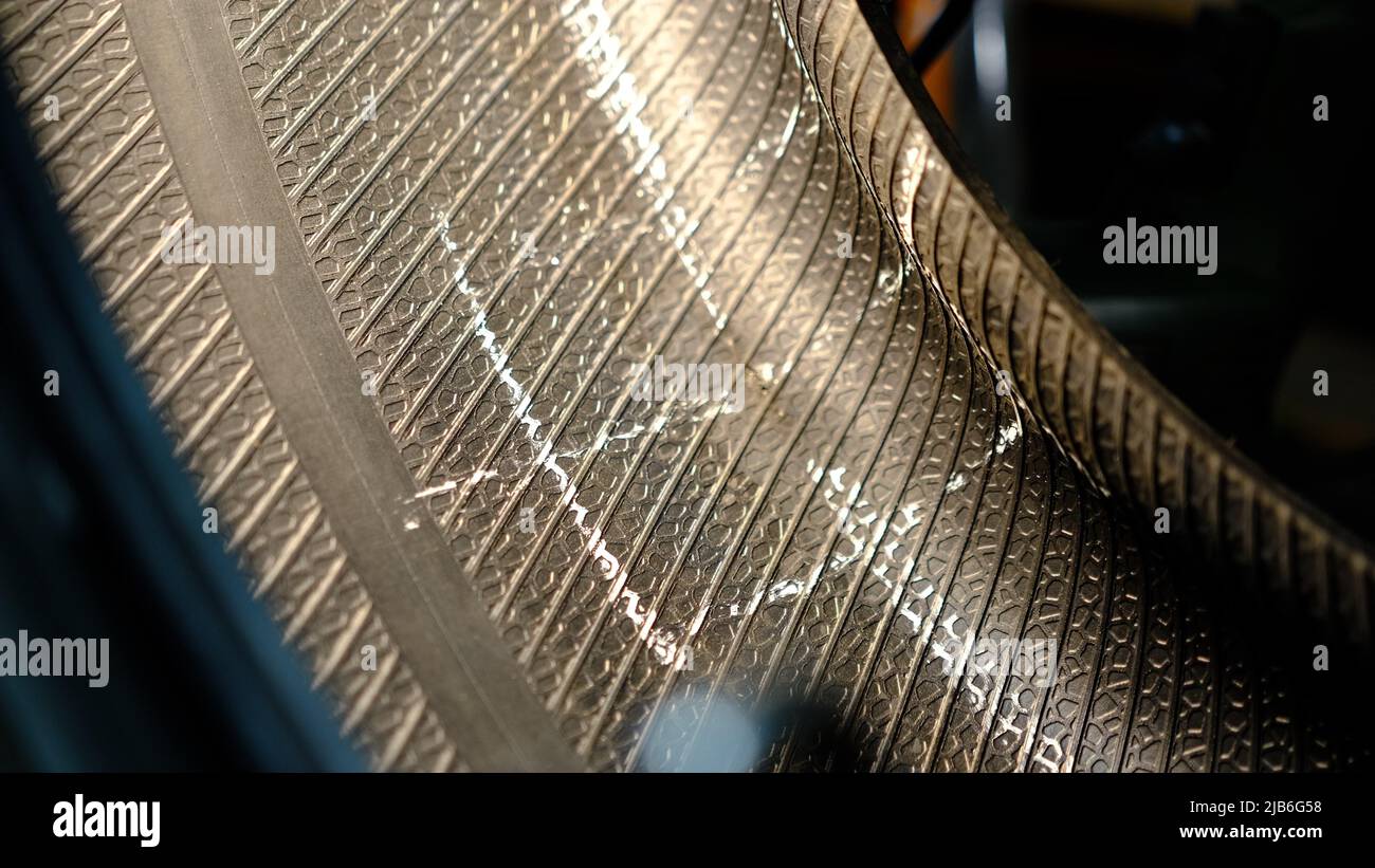 Repair service for wheel tire of car from big puncture. Close view of ...