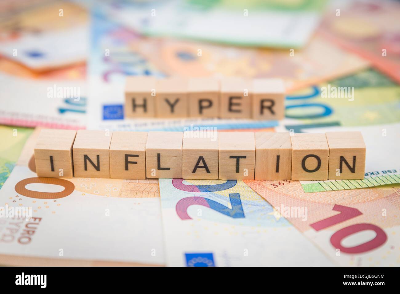 The word inflation and hyper in the background on banknotes Euro notes ...
