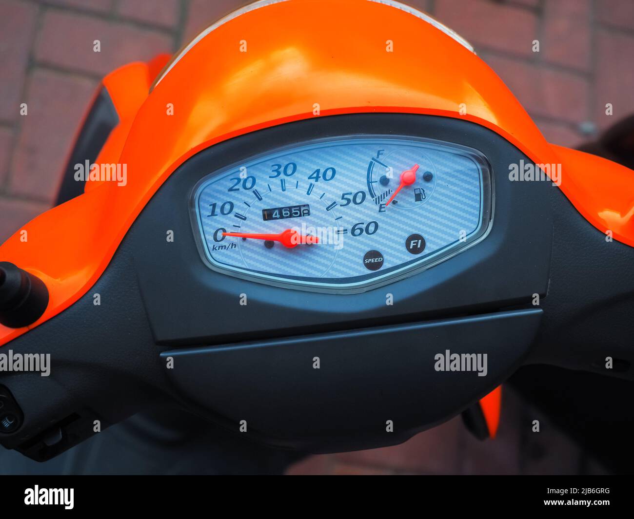 A speedometer with a dial and arrows is located on the steering wheel ...