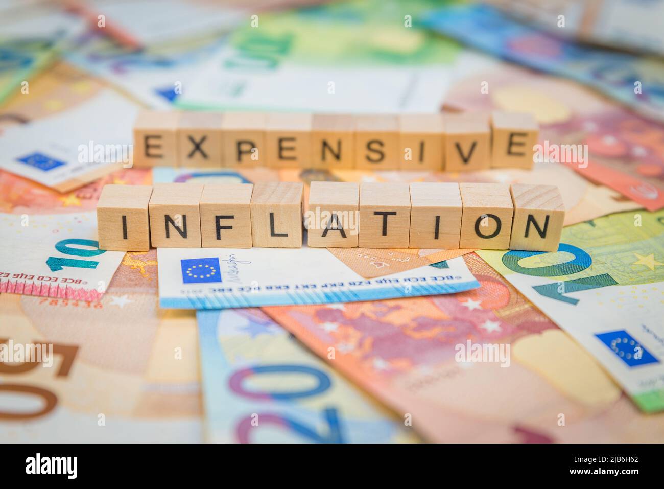 The word Inflation and Expensive in the background on banknotes Euro ...