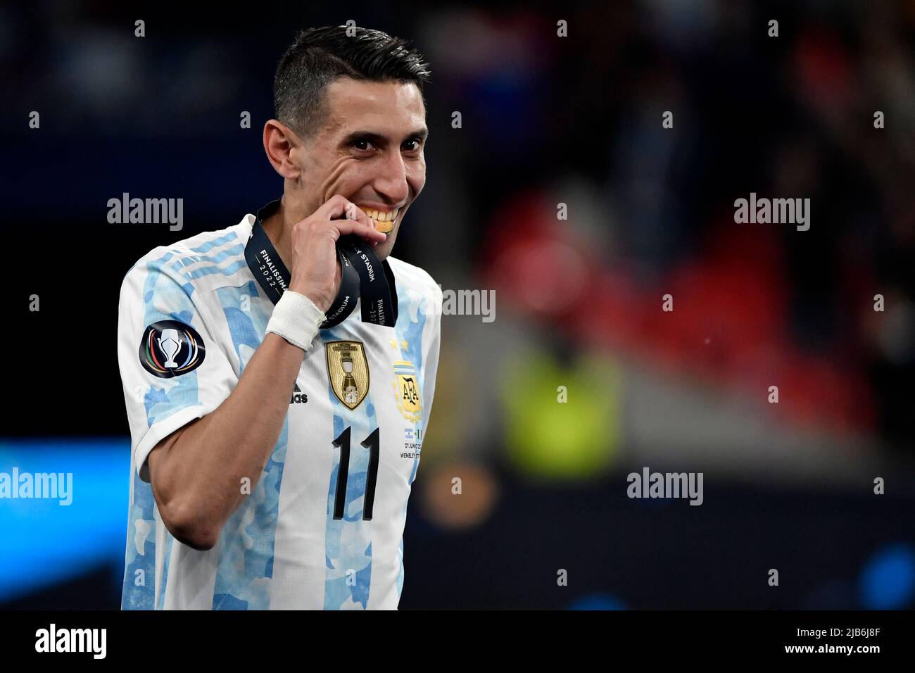 Angel Di Maria of Argentina bites the medal while celebrating at the ...