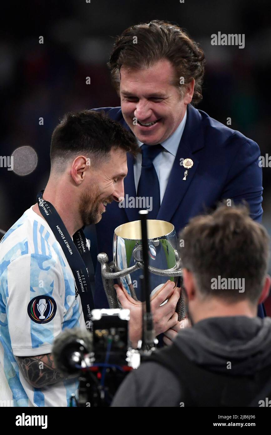 Lionel Messi of Argentina receives the trophy from Alejandro Dominguez ...