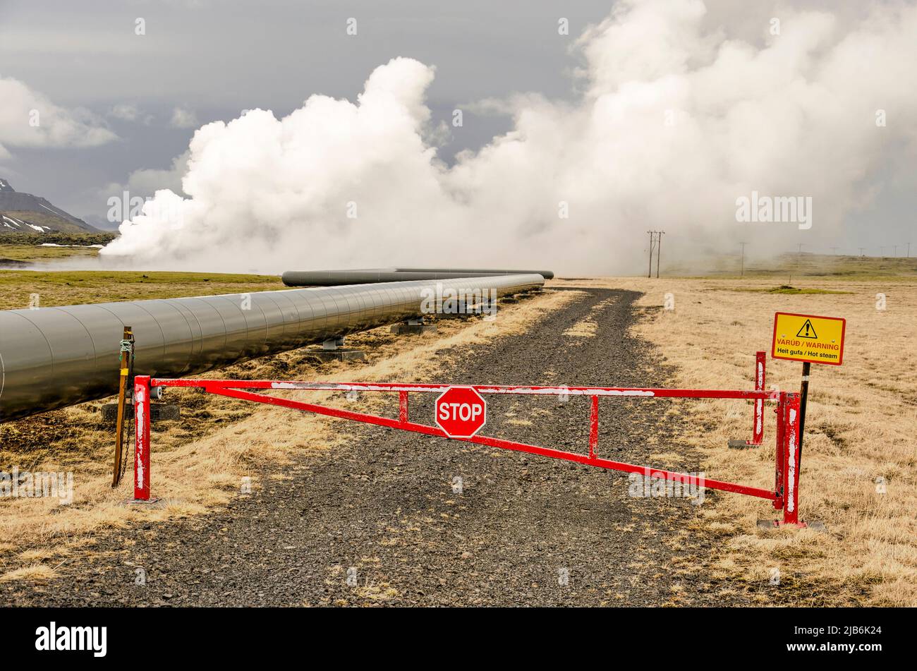 Hengill, Iceland, April 22, 2022: fence, road, pipeline, hot steam and ...