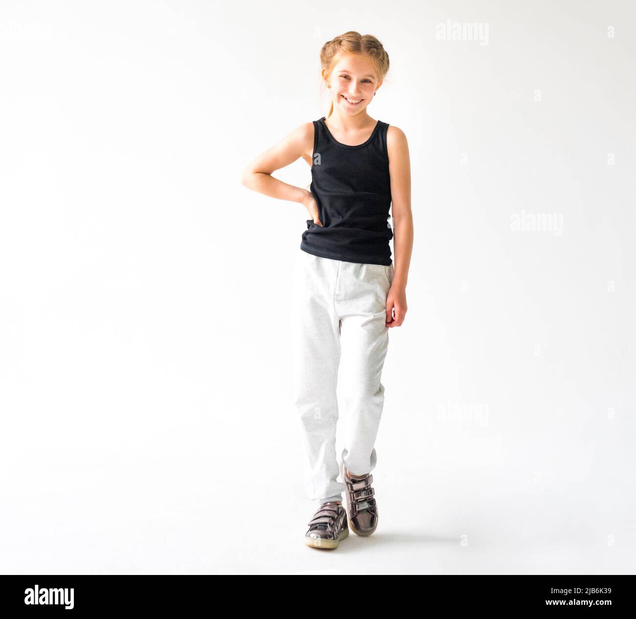 Little girl smiling standing in front of camera Stock Photo - Alamy
