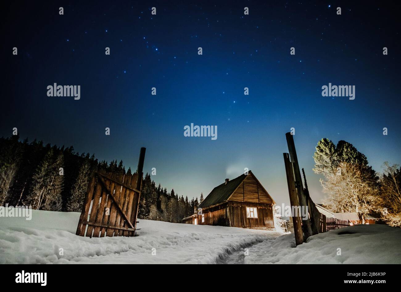 Wooden cottage with blue starry sky at night Stock Photo - Alamy