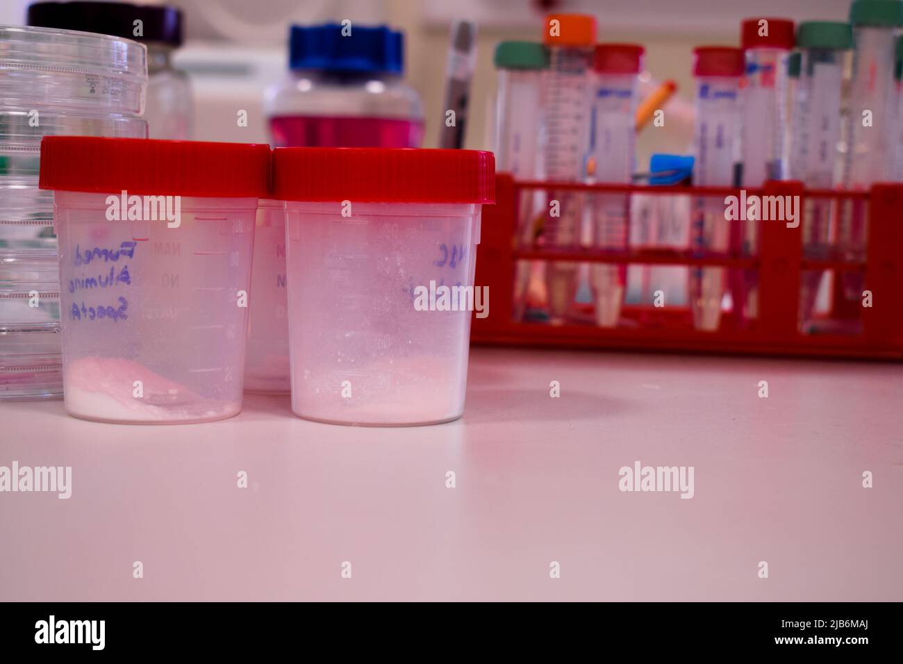 Red capped container holds a chemical agents on the table Stock Photo ...