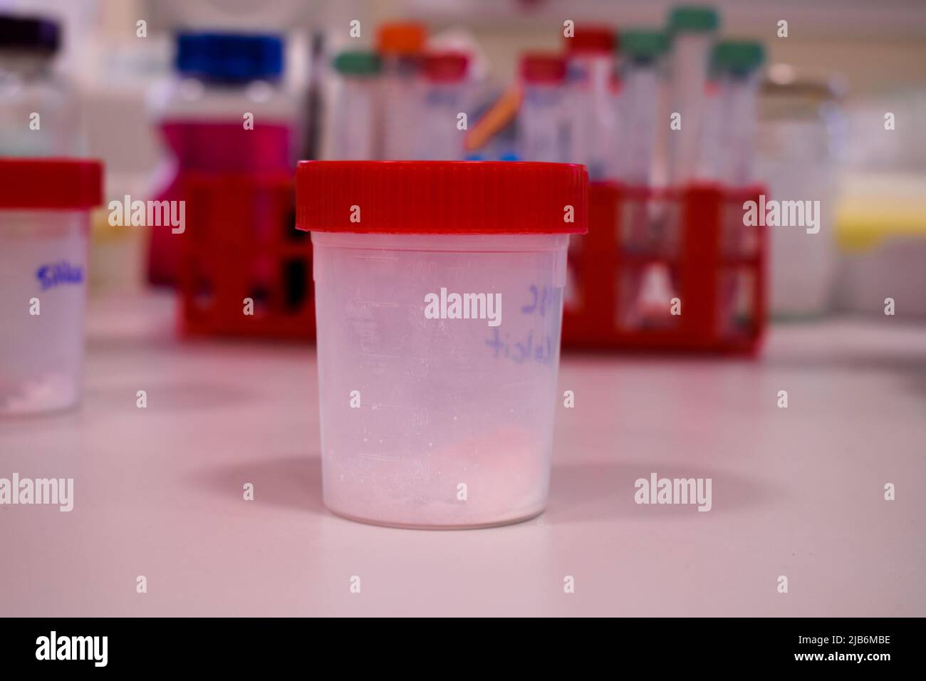 Red capped container holds a chemical agents on the table Stock Photo ...