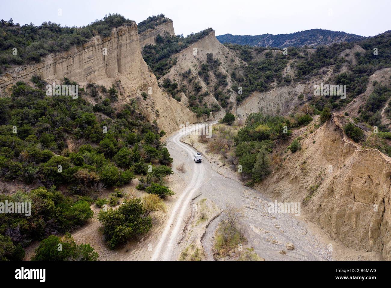 4x4 campervan driving trough dry riverbed, Vashlovani protected area ...