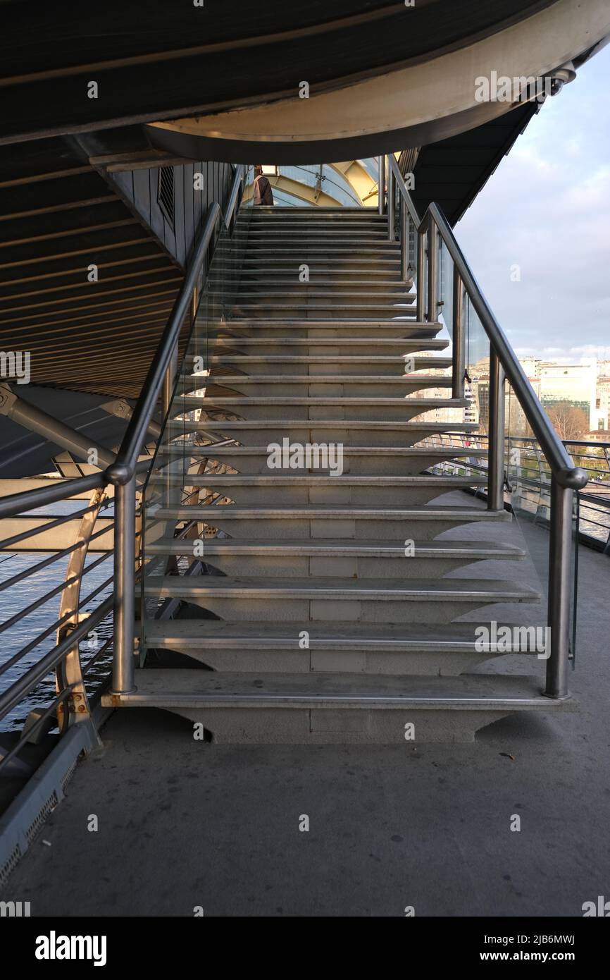 Stairs to the subway station on the bridge. Modern railway overpass is ...