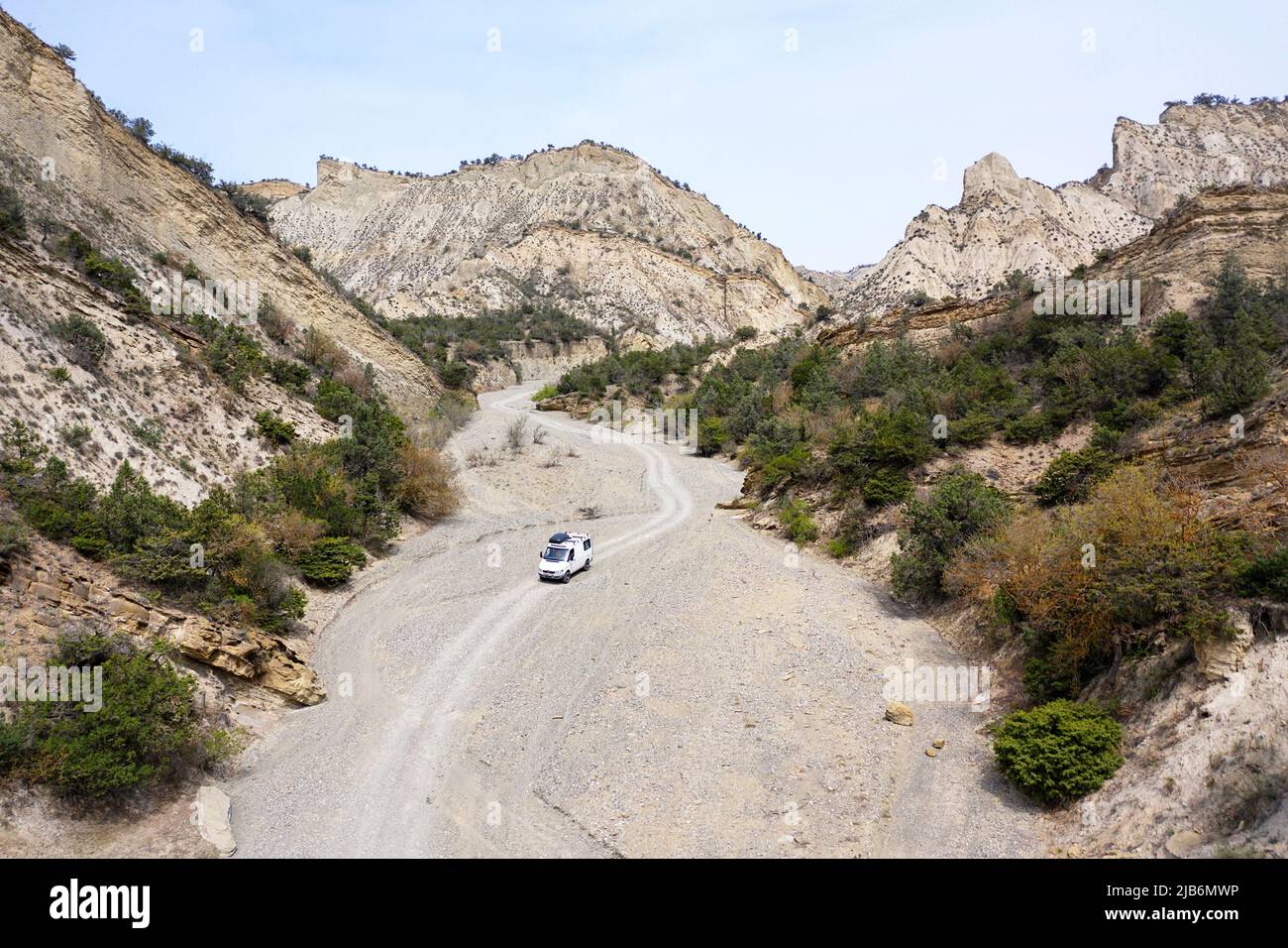 4x4 campervan driving trough dry riverbed, Vashlovani protected area ...