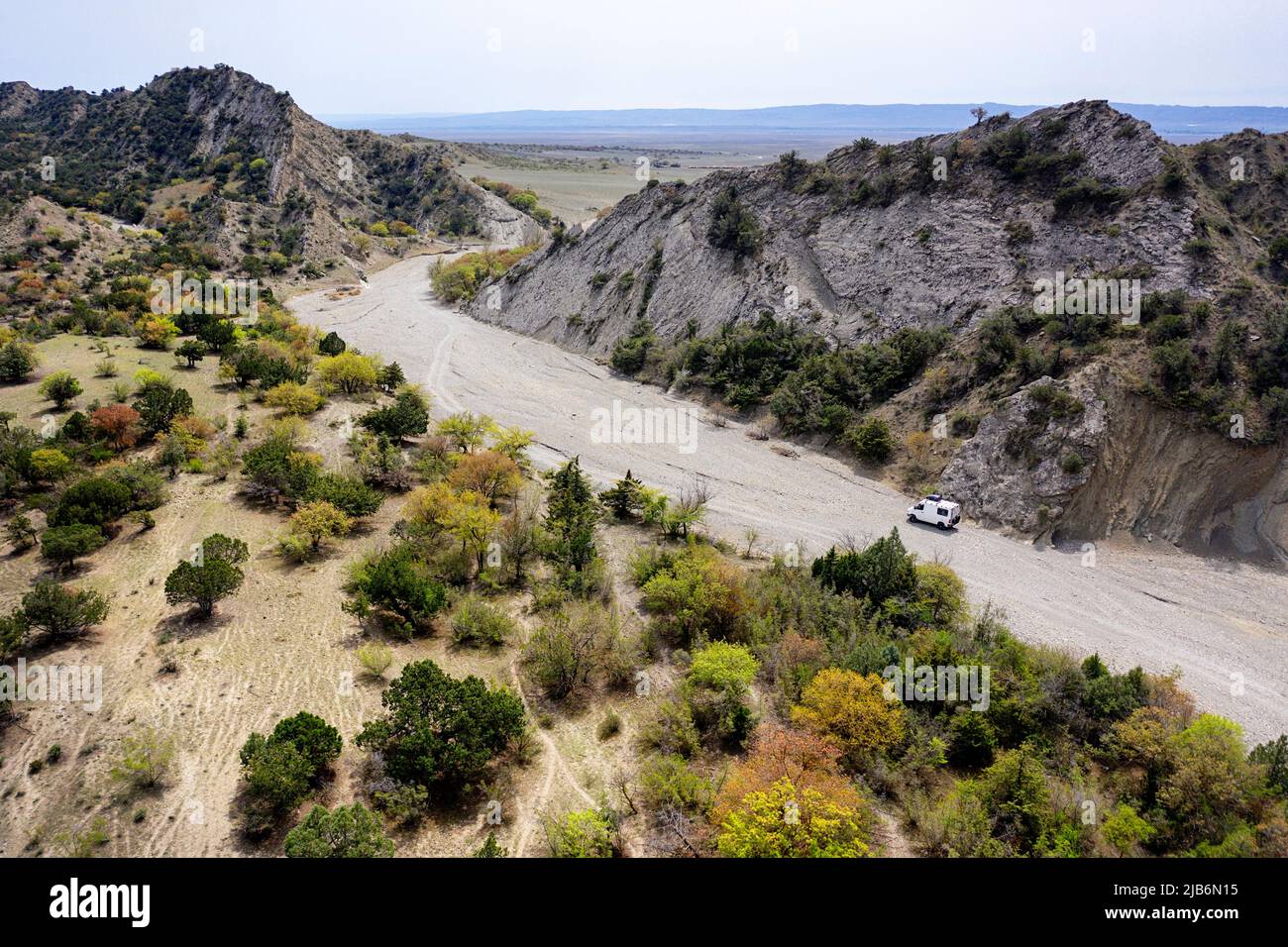 4x4 campervan driving trough dry riverbed, Vashlovani protected area ...