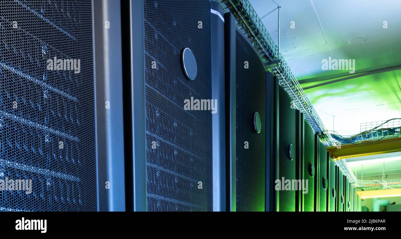 Image of empty corridor with row of green and blue computer servers ...