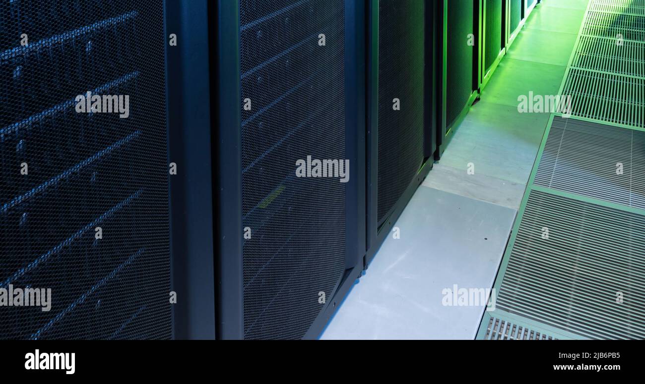 Image of empty corridor with row of green and blue computer servers ...