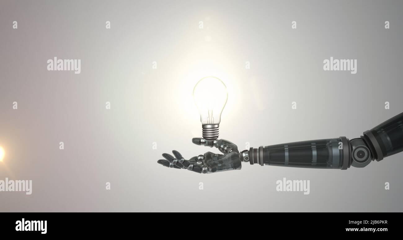 Image of illuminated light bulb over hand of extended robot arm, on ...