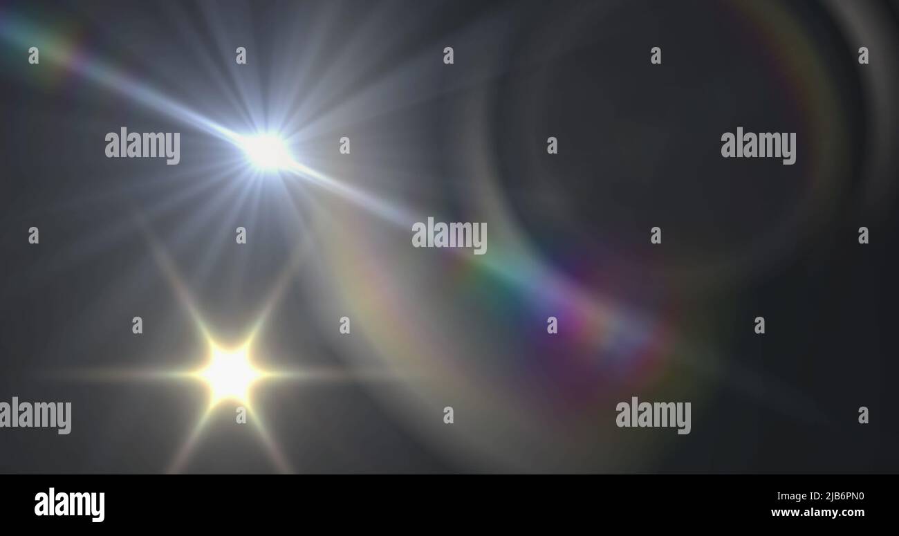 Image of white light with beam and prismatic lens flare on dark ...