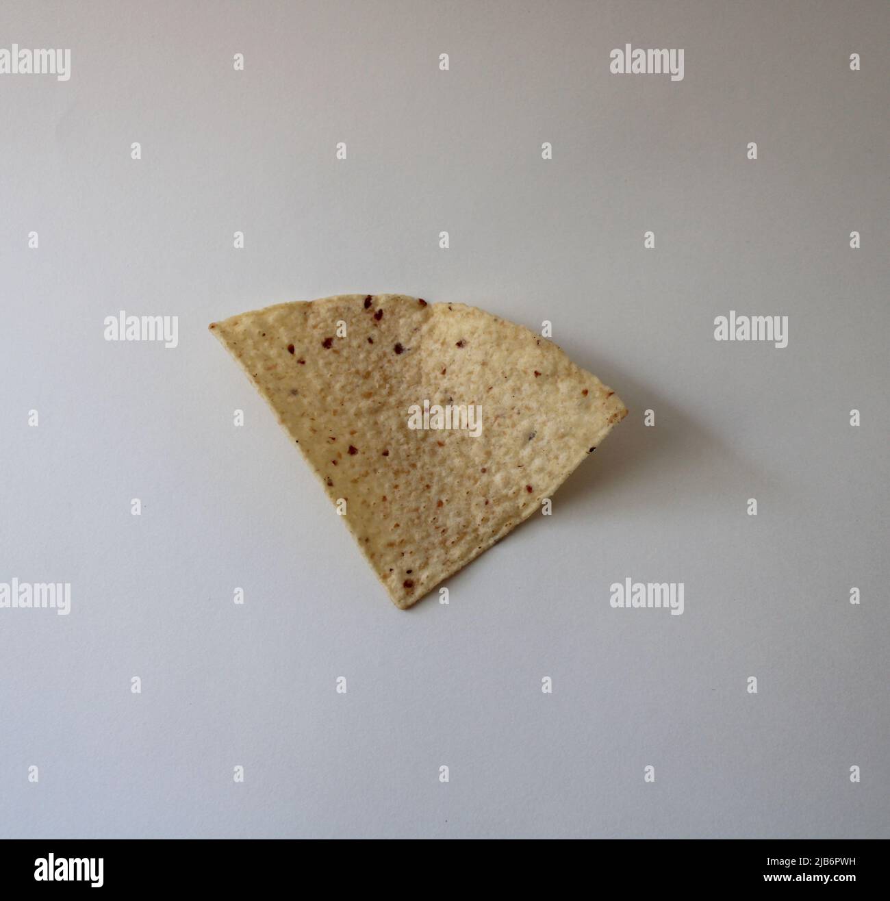 A Single Yellow Corn Tortilla Chip on a White Background Stock Photo ...