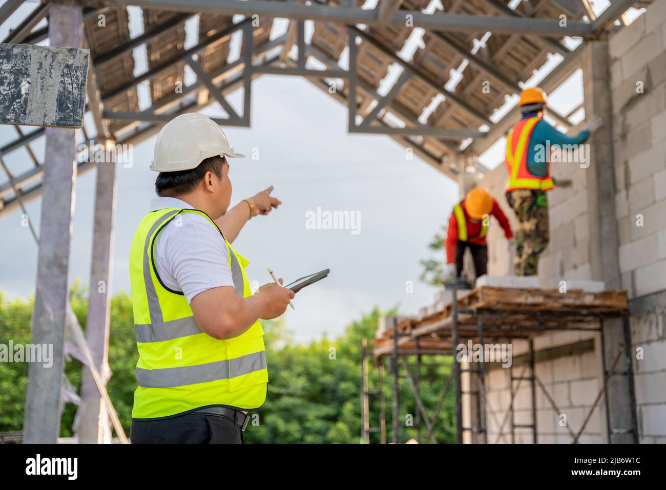 Asian Civil Engineers are working with construction workers who are ...
