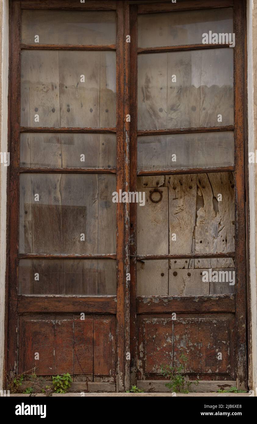 Close-up of a wooden and glass door of a house, in a state of ...