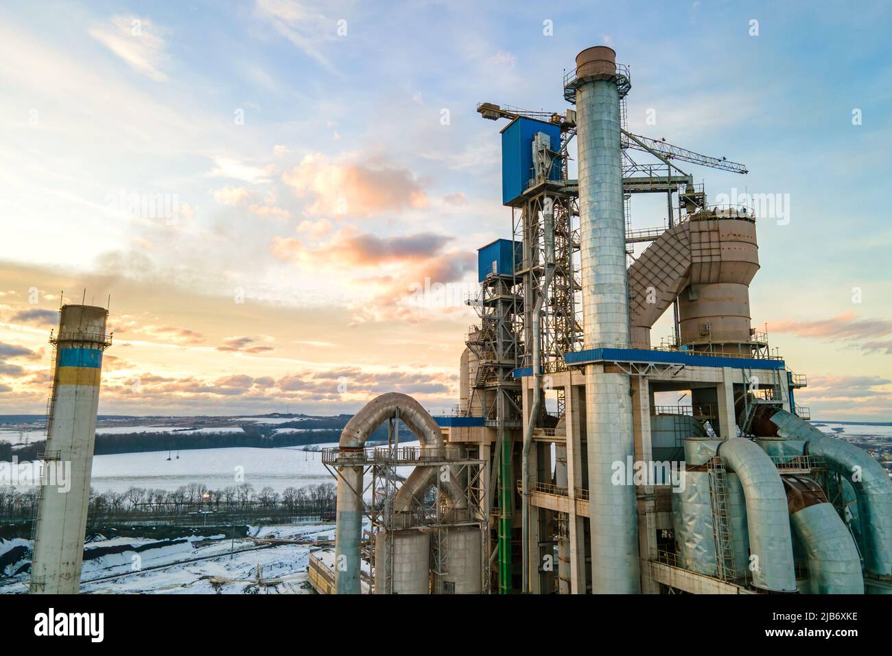Aerial view of cement plant with high factory structure and tower crane ...