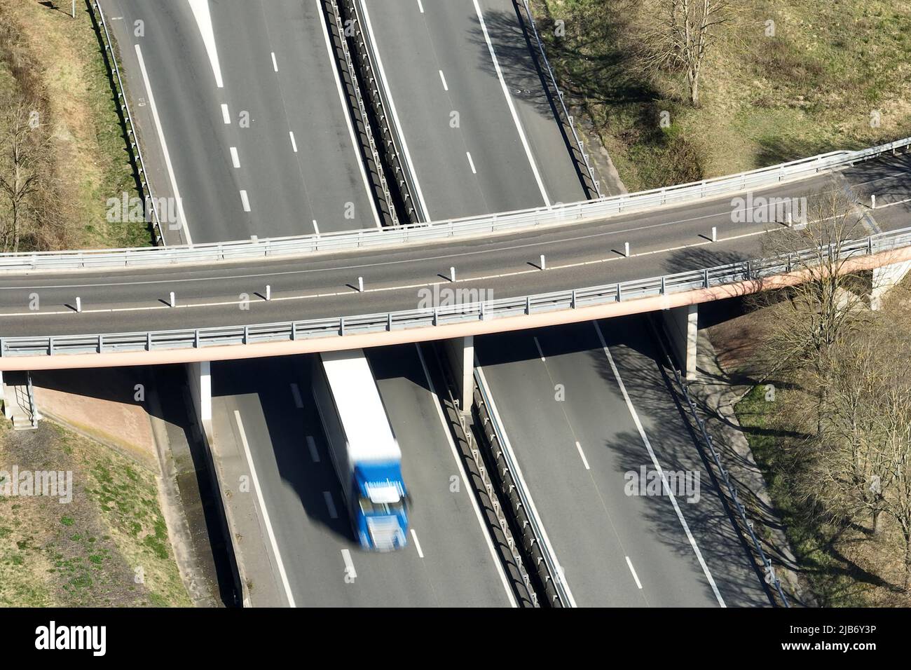 Aerial view of highway road intersection with fast moving heavy traffic ...