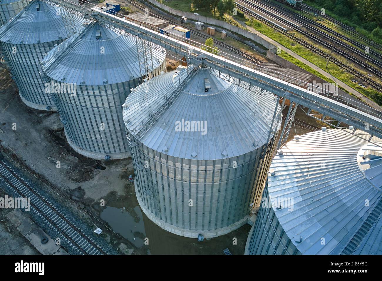 Aerial view of industrial ventilated silos for long term storage of grain and oilseed. Metal ...
