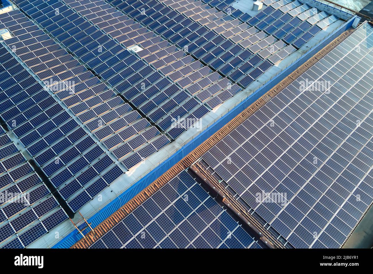 Aerial view of solar power plant with blue photovoltaic panels mounted ...