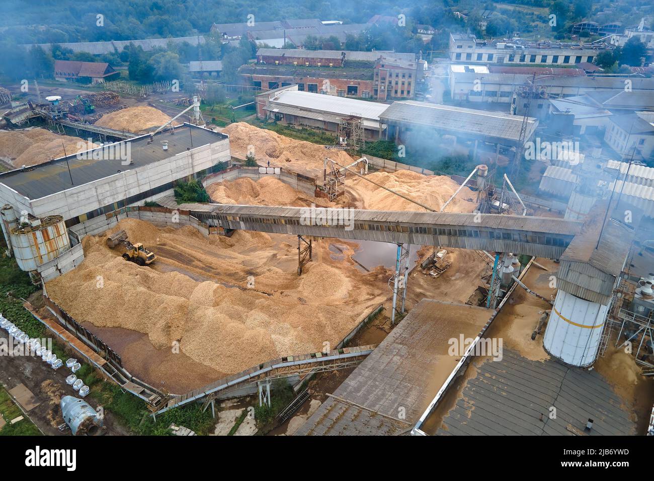 Aerial view of wood processing factory with smoke from production ...