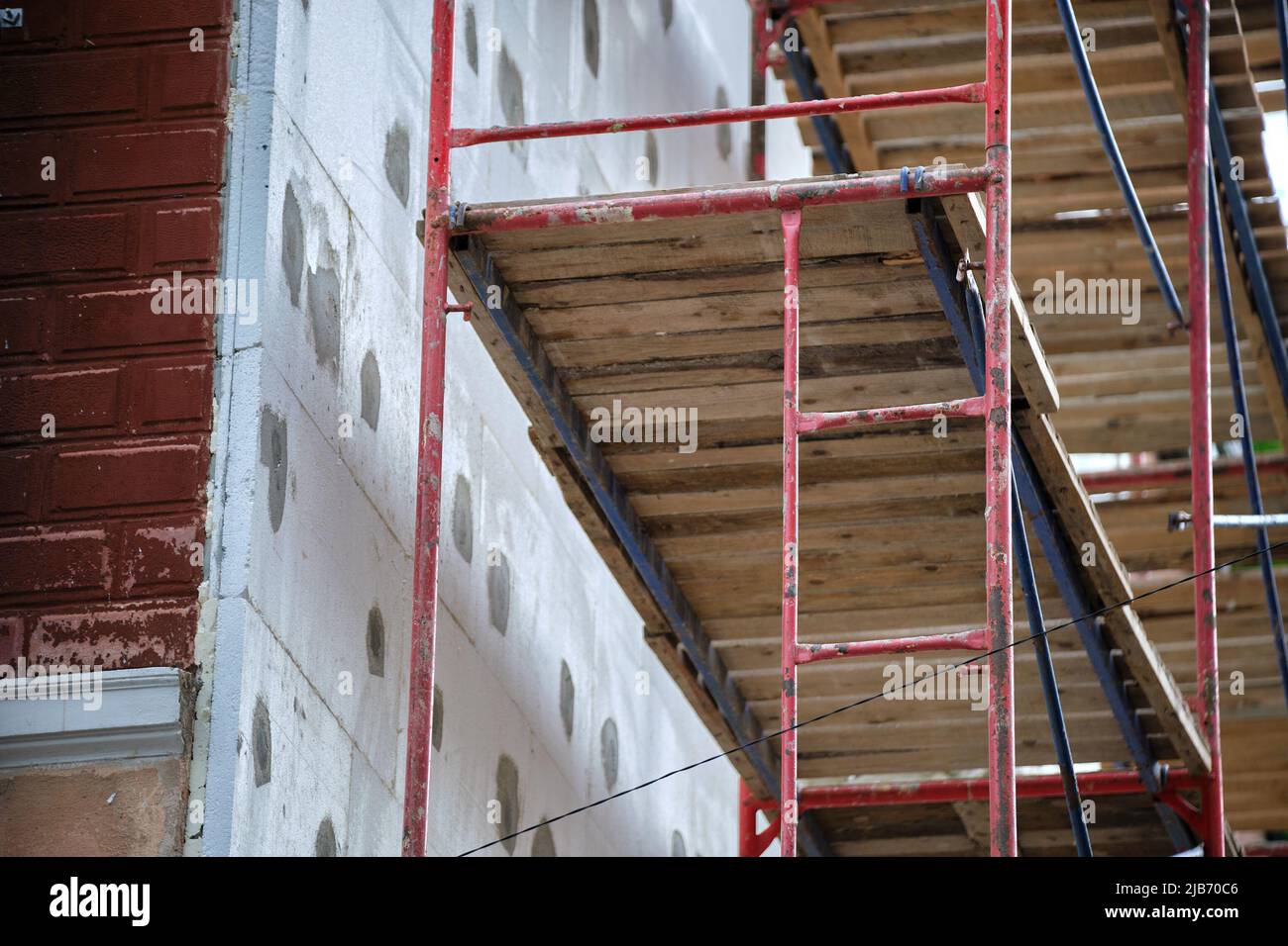 Building facade under renovation works with construction scaffolding ...