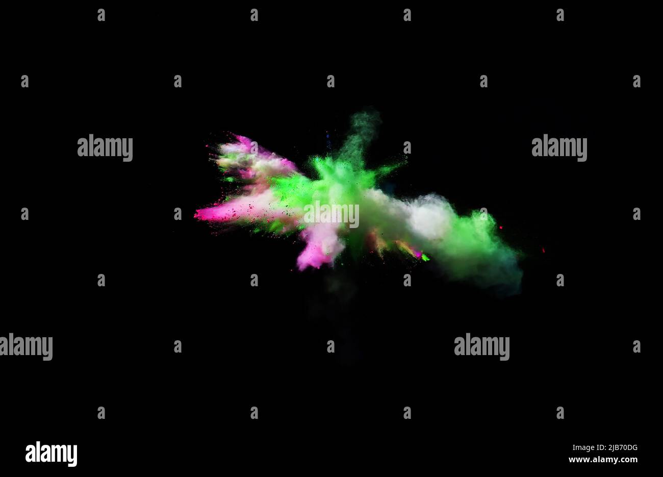 Various multicolored forms of powder paint explode in front of a black ...