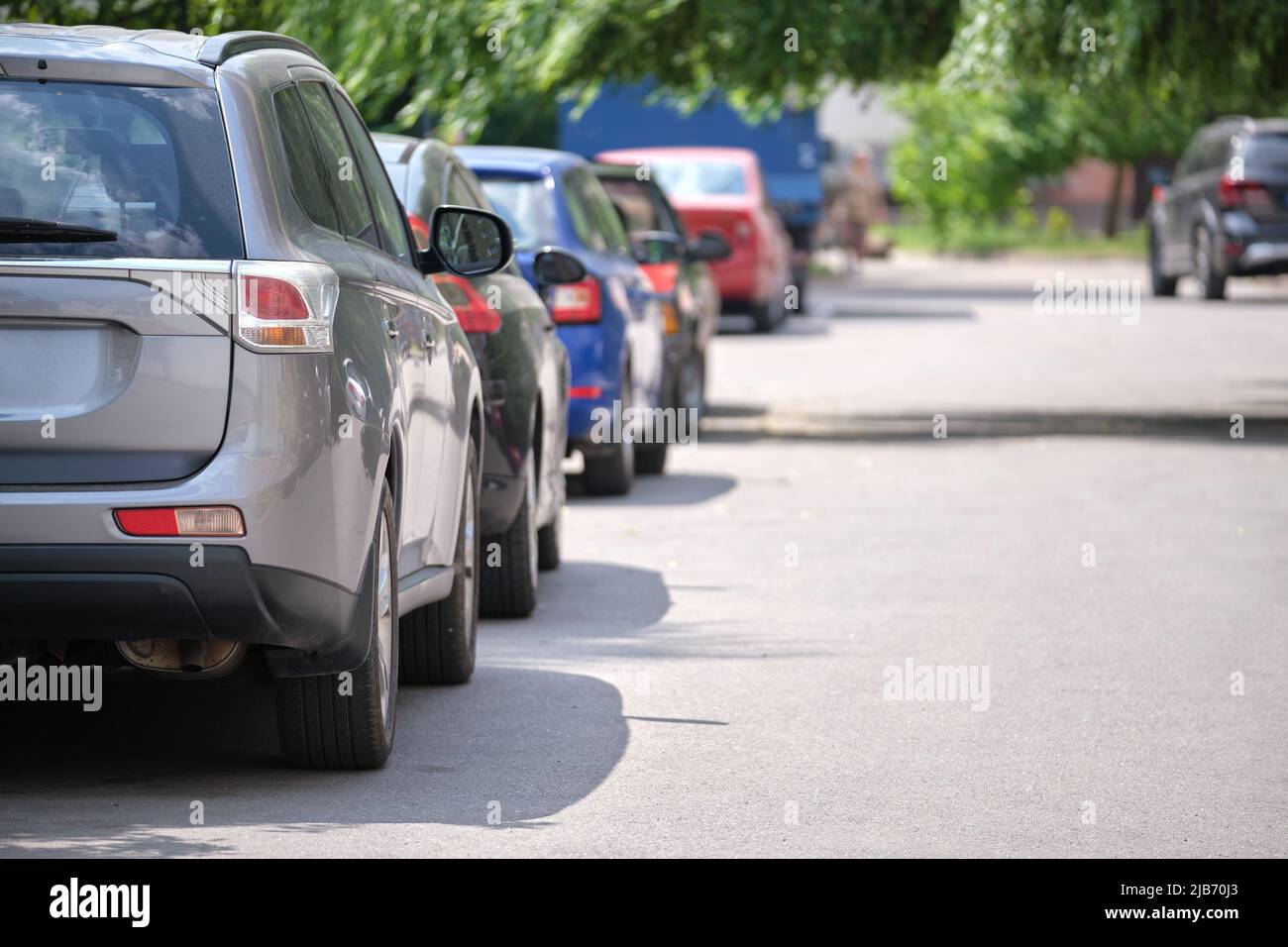 Cars parked in line on city street side. Urban traffic concept Stock ...