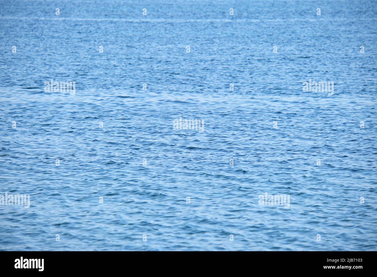 Closeup seascape surface of blue sea water with small ripple waves ...