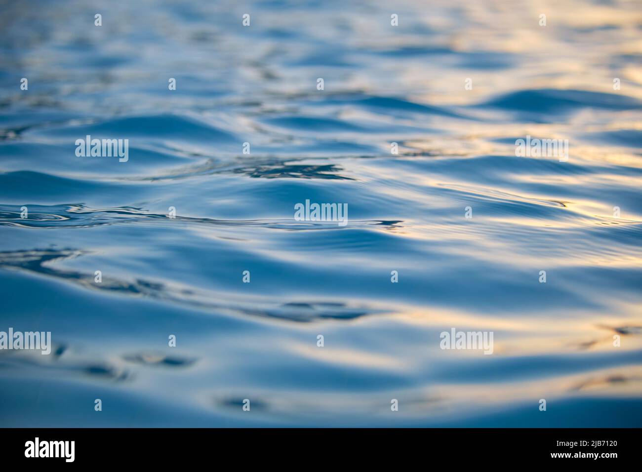 Closeup seascape surface of blue sea water with small ripple waves ...
