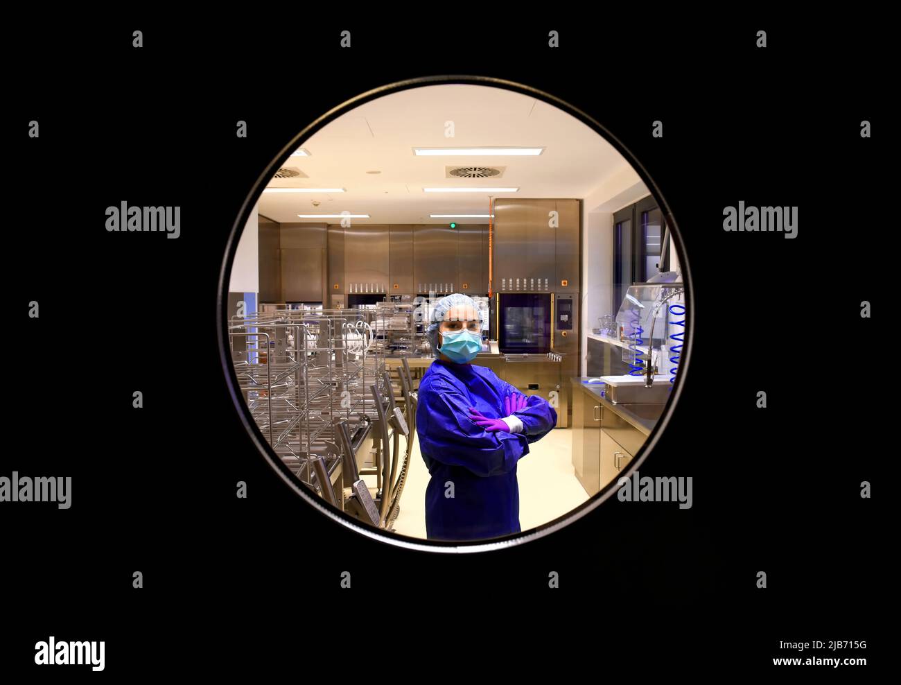 A girl works in a hospital as a medical hygiene worker. Dressed in ...