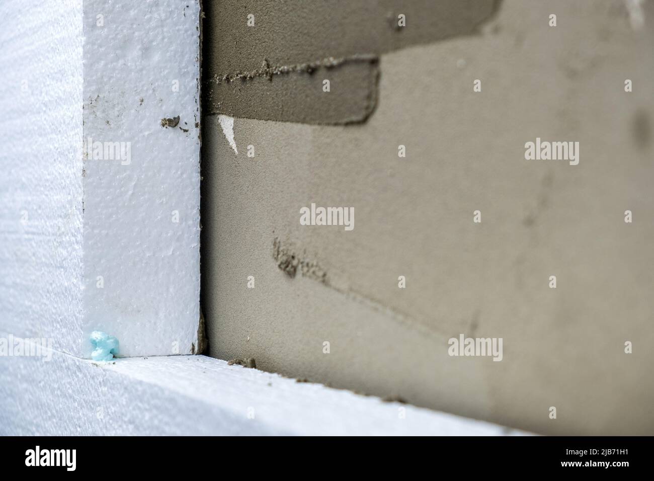 Installation of styrofoam insulation sheets on house facade wall for ...