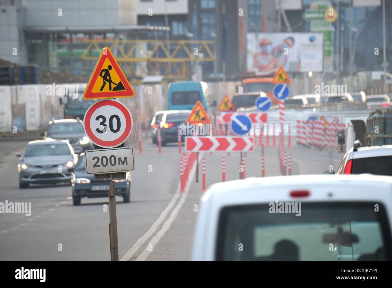 Roadworks warning traffic signs of construction work on city street and ...
