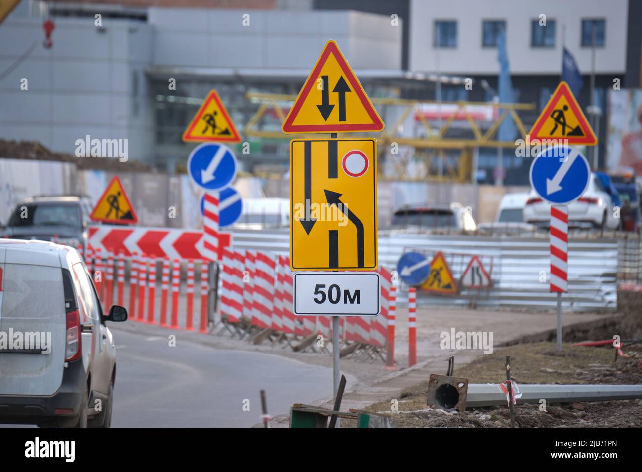 Roadworks warning traffic signs of construction work on city street and ...