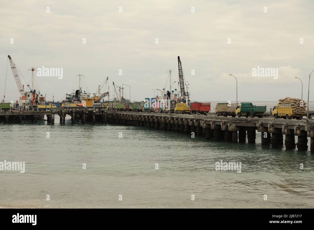 Cargo trucks waiting in a line on the pier to drop cargo at Waikelo ...