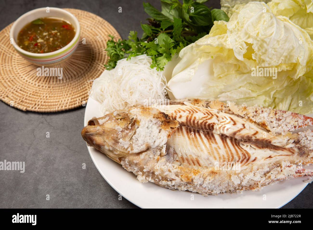 Grilled tilapia with salt and seafood sauce Stock Photo - Alamy