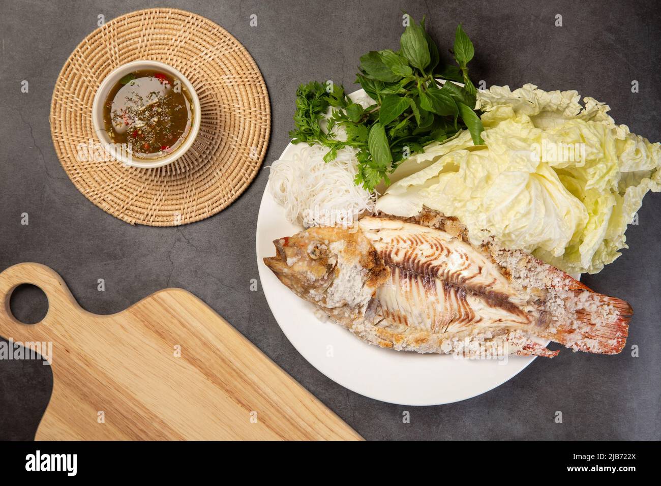 Grilled tilapia with salt and seafood sauce Stock Photo - Alamy