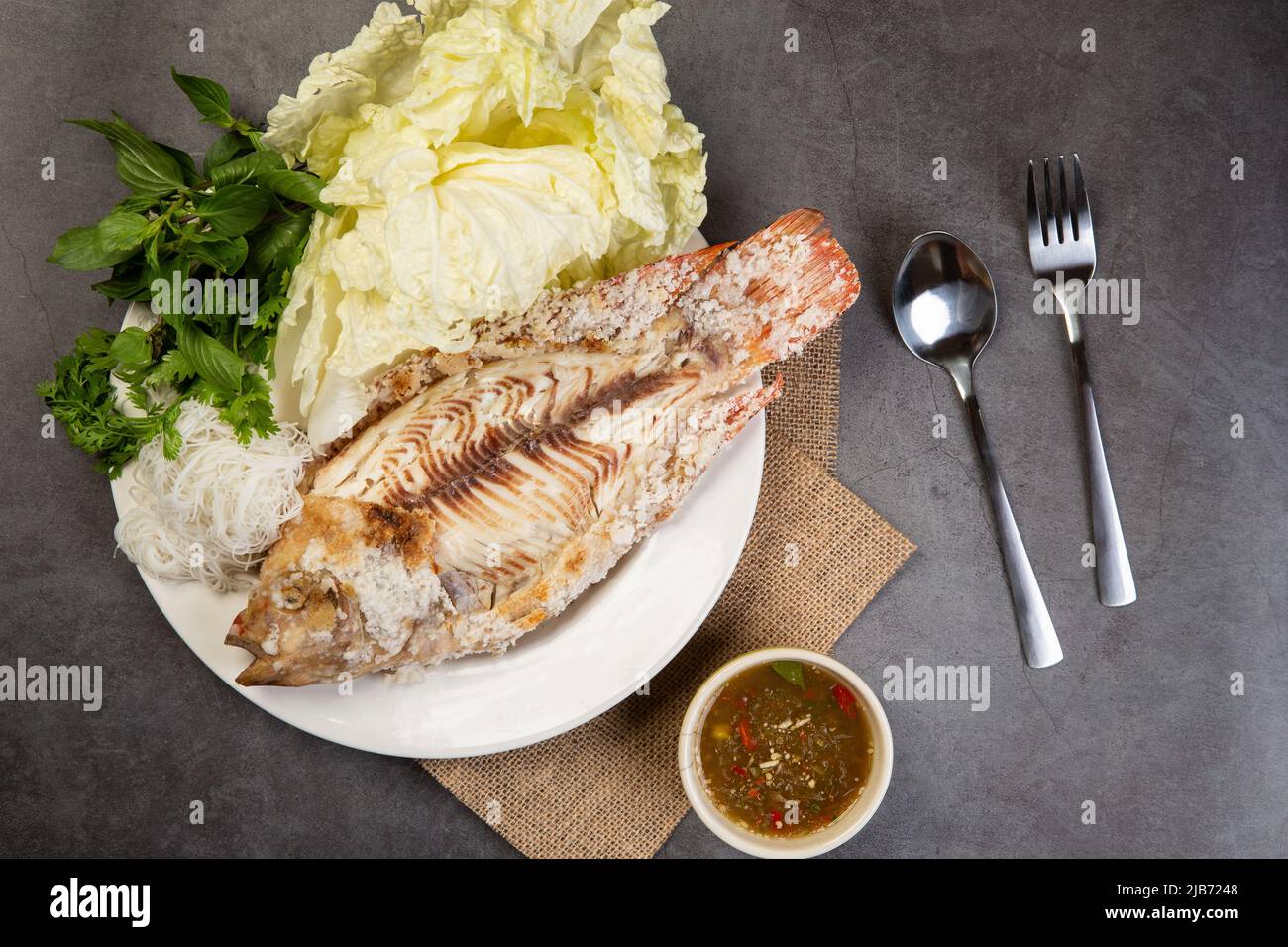 Grilled tilapia with salt and seafood sauce Stock Photo - Alamy