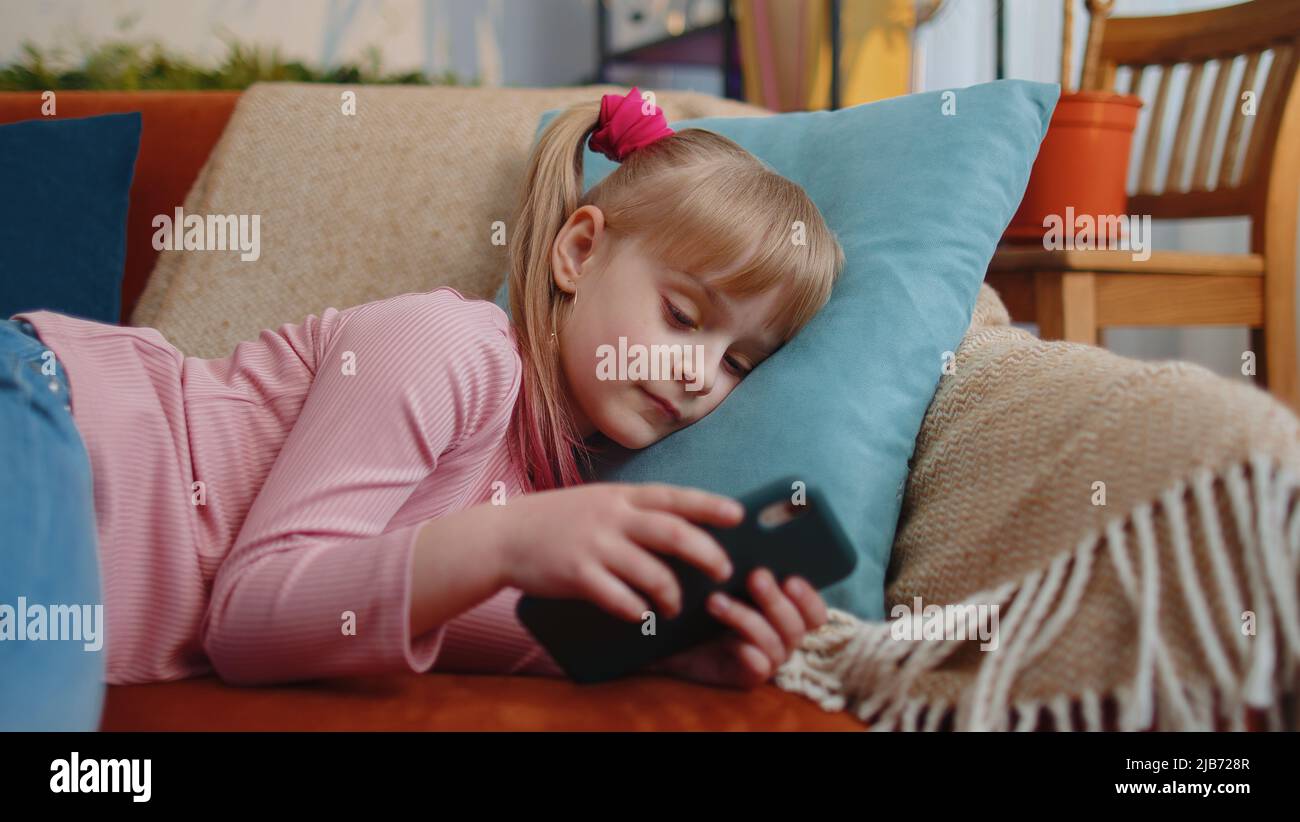 Child toddler hold smartphone watching funny cartoons, chatting with ...