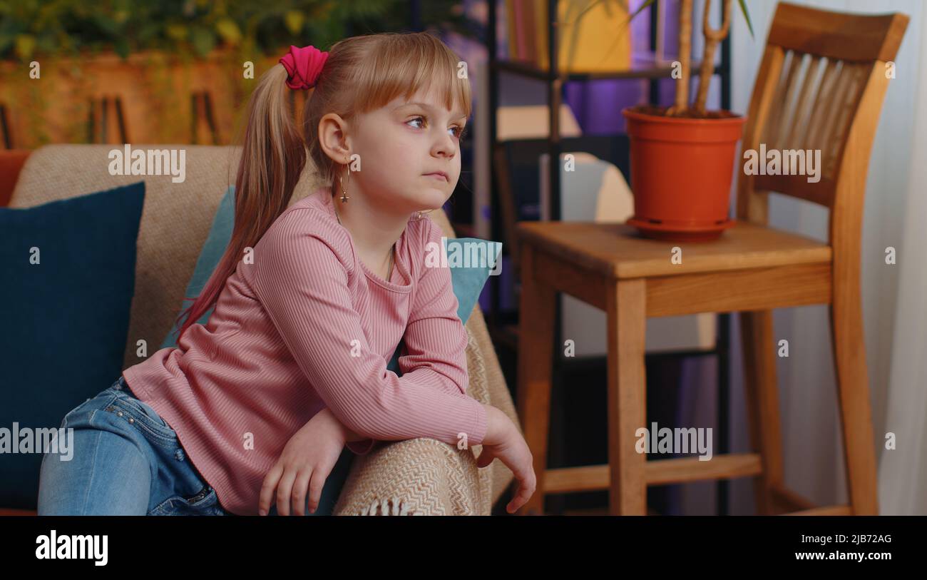 Sad little teen child girl looks pensive thinks over life concerns ...