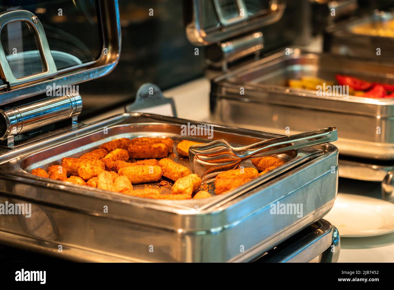 Heated buffet containers with potato sticks for breakfast in hotel ...