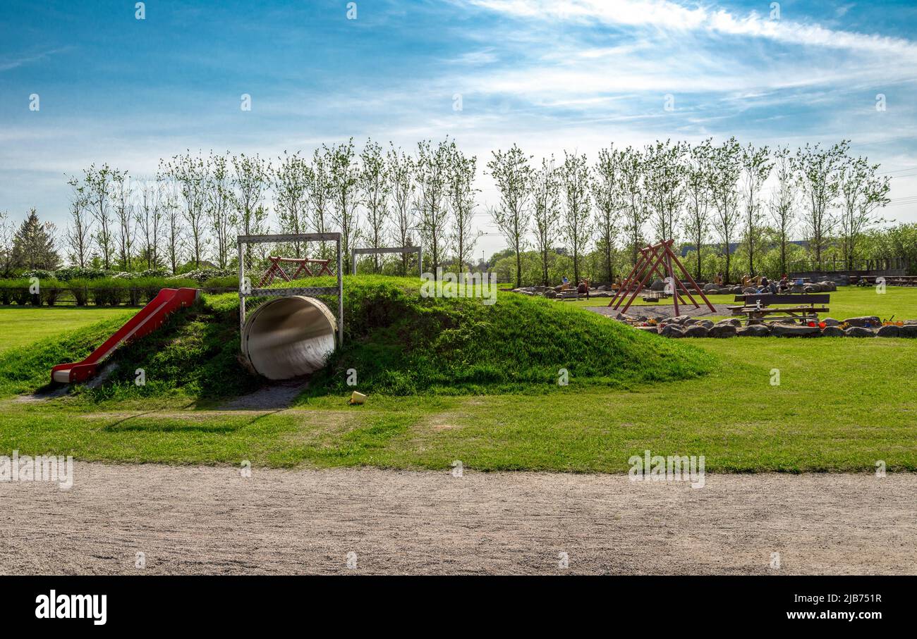 Scenic playground with a tunnel through the grass hill, Soma farm ...